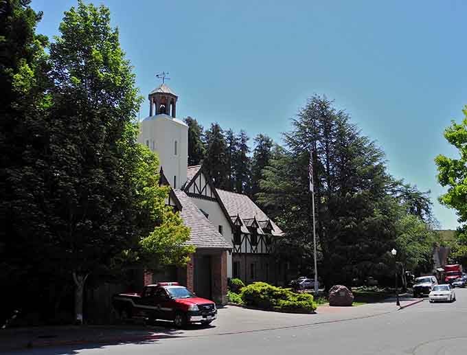 A charming bell tower surrounded by towering trees creates the kind of storybook setting you'd expect in Europe.