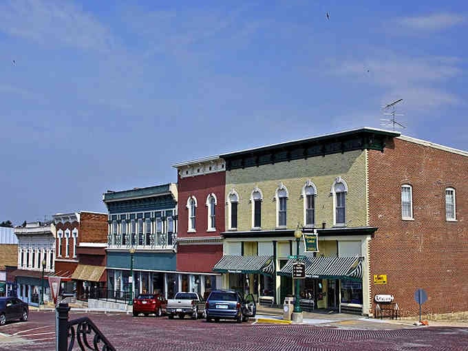 These colorful storefronts line up like a box of crayons, each one adding its own personality to the town square.