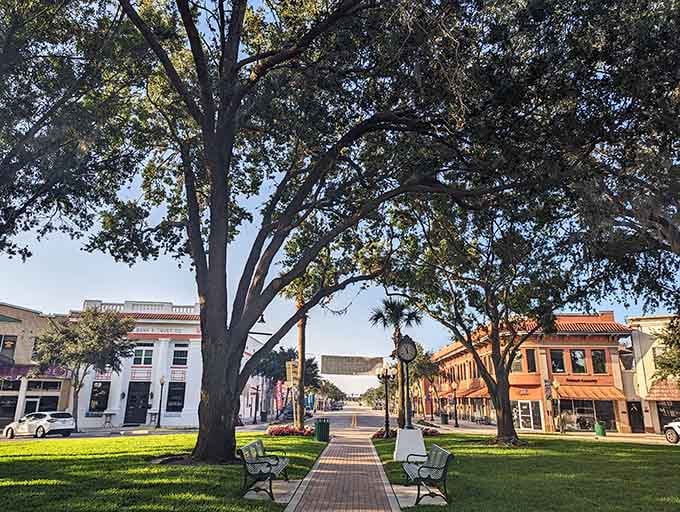 Majestic oaks create a canopy over brick walkways where your biggest decision is which bench to claim.