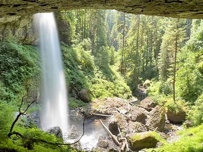 Standing behind a waterfall feels like discovering nature's secret room, complete with your own private mist shower.