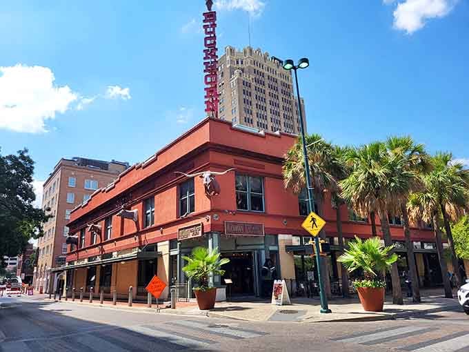 That bold vertical sign and coral-colored building have been drawing curious visitors inside for well over a century.
