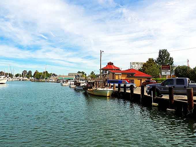 Working boats bob gently at the dock, their colorful hulls reflecting a waterman's life lived by tide tables.