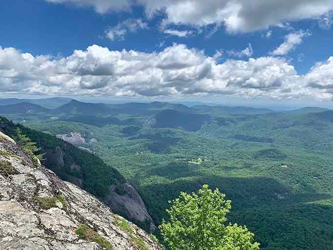 Those white granite cliffs drop away like nature's own skyscraper, revealing layers of ancient rock and endless mountain views.