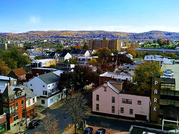 Hills roll beyond the rooftops in layers of blue and green, proving small cities can offer big views without the big price tags.