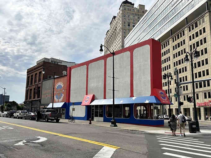 The bold geometric facade stands proud among city buildings, a temple dedicated to the art of the perfect coney dog.
