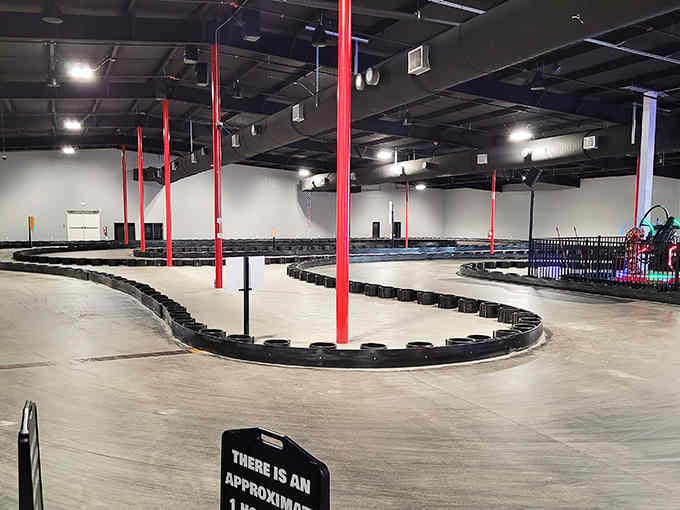 Spacious indoor facility with bright red accents shows someone understood that great racing needs room to breathe and grow.