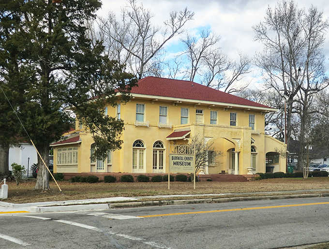 That cheerful yellow museum building stands proud, preserving local stories worth discovering on any lazy afternoon.