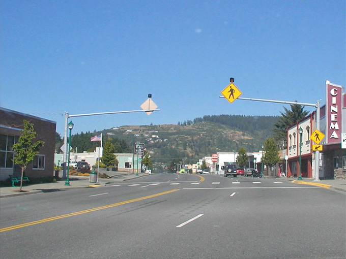 Main street stretches toward distant mountains, inviting exploration of shops and cafes tucked into buildings that remember simpler times.