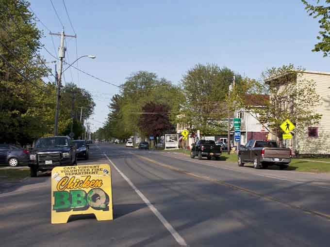That cheerful BBQ sign promises good eating ahead on this tree-lined main drag through town.