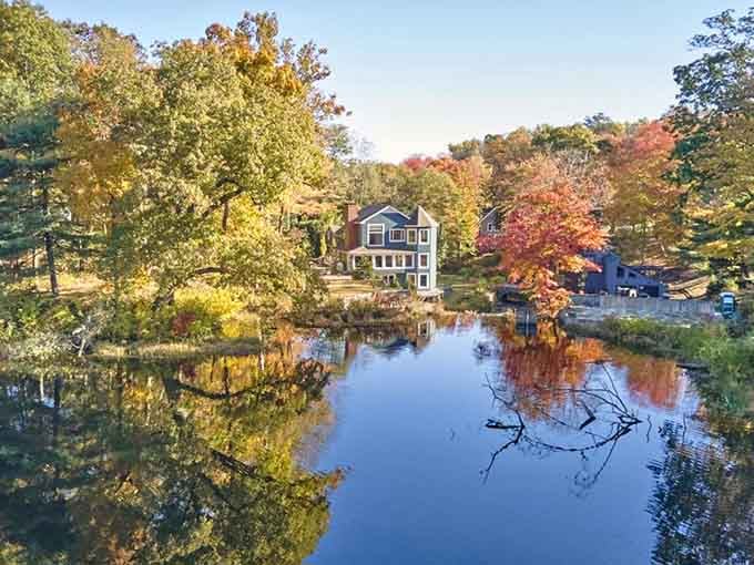 Fall foliage frames the still water creating a mirror image that doubles the beauty.