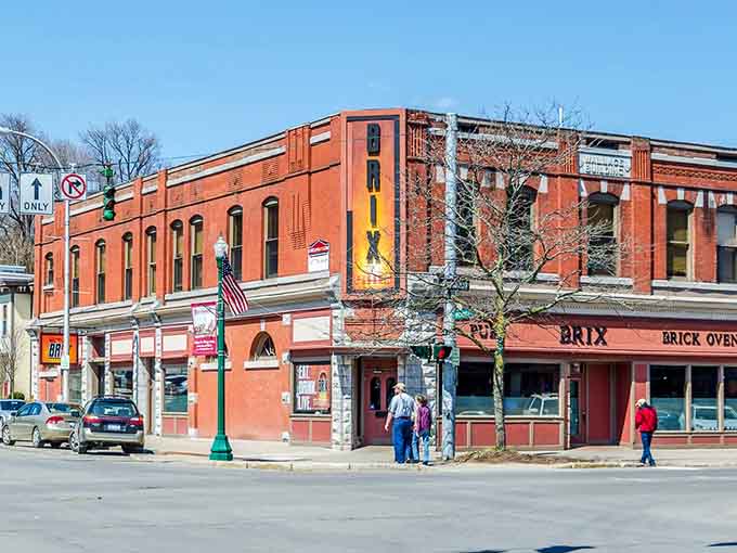 Brick facades glow warmly on corner streets where pizza joints and pubs serve communities that actually feel like home.