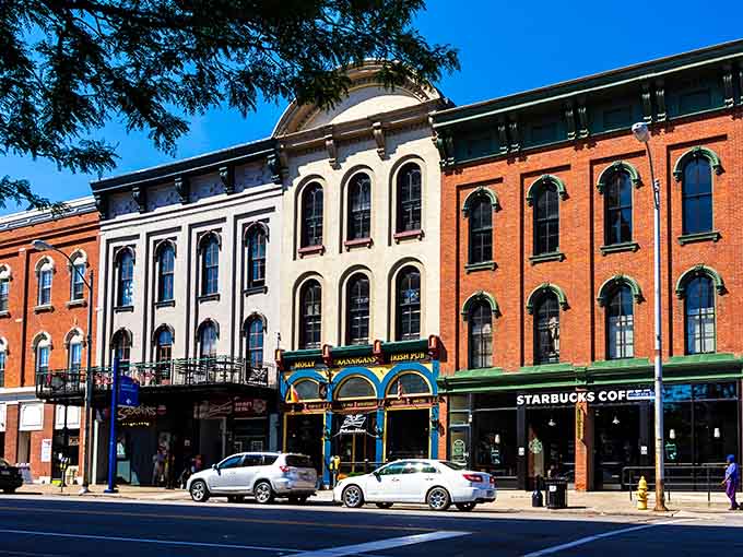 Those magnificent arched windows catch the sunlight, transforming ordinary storefronts into something worthy of a postcard.