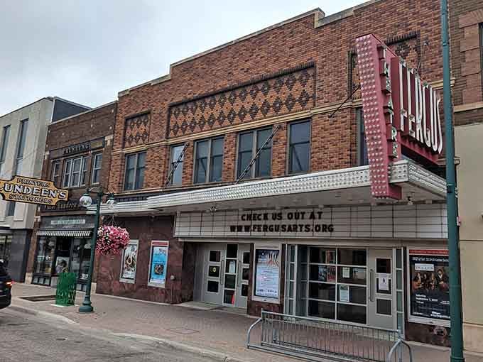 That vintage theater marquee promises entertainment under brickwork patterns that craftsmen spent months perfecting with pride and care.