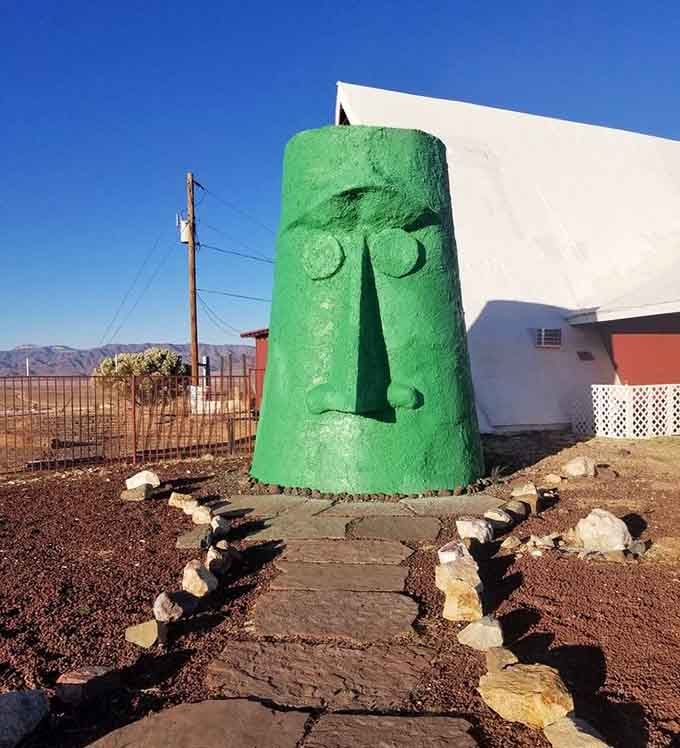 That stern green face watches over the highway like a stoic guardian transplanted from a distant Pacific island paradise.