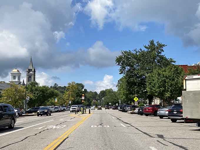 Church steeples pierce the sky while tree canopies create natural shade along these peaceful, walkable streets.