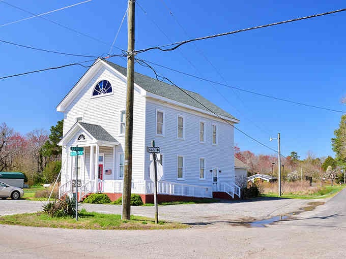This classic white church anchors a quiet island corner where Sunday services have echoed for generations.
