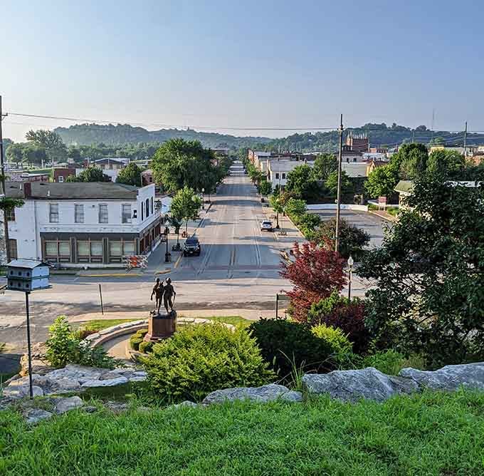 Morning light catches tree-lined streets stretching toward rolling hills, proving small-town views beat skyscraper canyons every time.