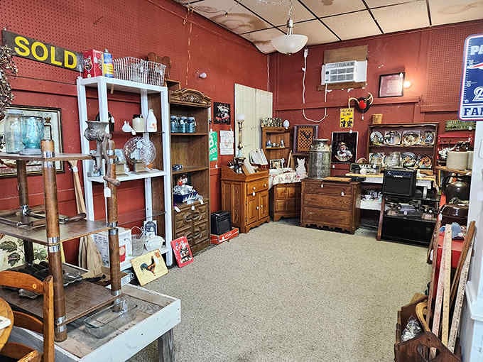 Rich red walls create the perfect backdrop for vintage furniture and collectibles that span generations of American craftsmanship.