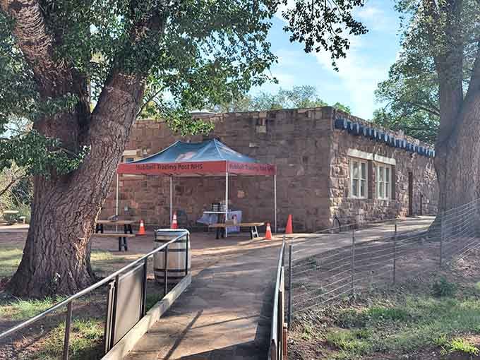 Shaded walkways and historic stonework create a peaceful sanctuary where the National Park Service preserves authentic trading post traditions beautifully.