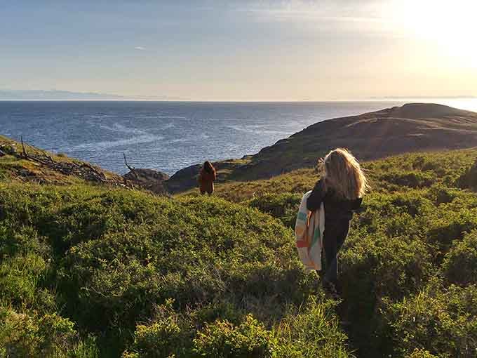 A solitary hiker stands silhouetted against the Pacific, contemplating life's big questions or maybe just dinner plans.