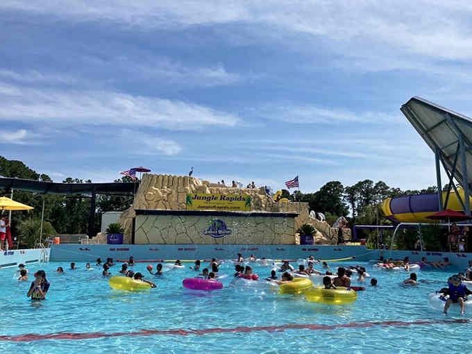 The wave pool fills with colorful tubes and happy swimmers enjoying their slice of tropical paradise.
