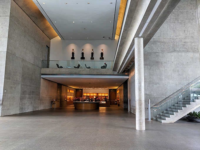 This soaring lobby proves that concrete and warm wood can create spaces as inviting as any masterpiece.