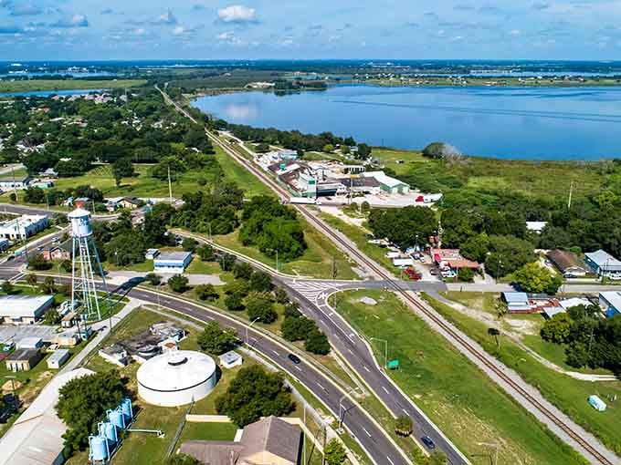 The wide road stretches toward sparkling water, connecting small-town life to big lake adventures without the premium price tag.