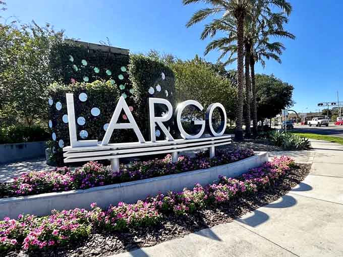 The Largo sign blooms with flowers like a welcome mat announcing you've arrived somewhere special worth exploring thoroughly.