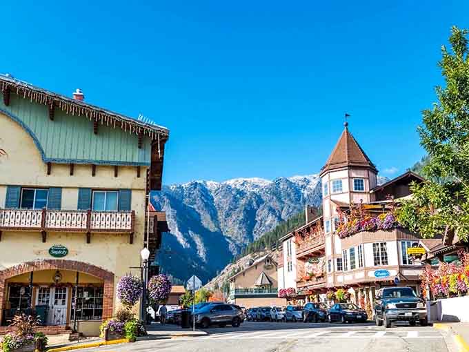 Those snow-capped mountains rising behind the alpine village create a view that belongs on a travel magazine cover.