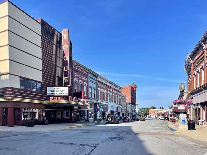 The Vogue Theatre's vertical sign towers over a street where history and community still matter more than chain stores.