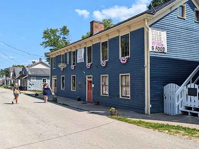 Historic buildings wear their patriotic bunting proudly, celebrating heritage along these quiet, tree-lined streets.