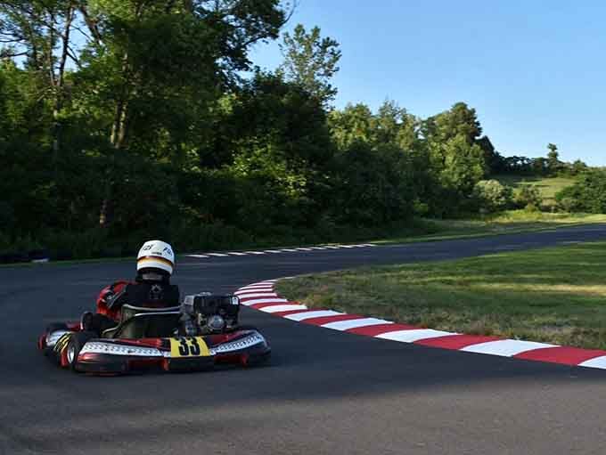 A lone racer attacks the track with determination, proving that outdoor karting is pure, unfiltered racing joy.