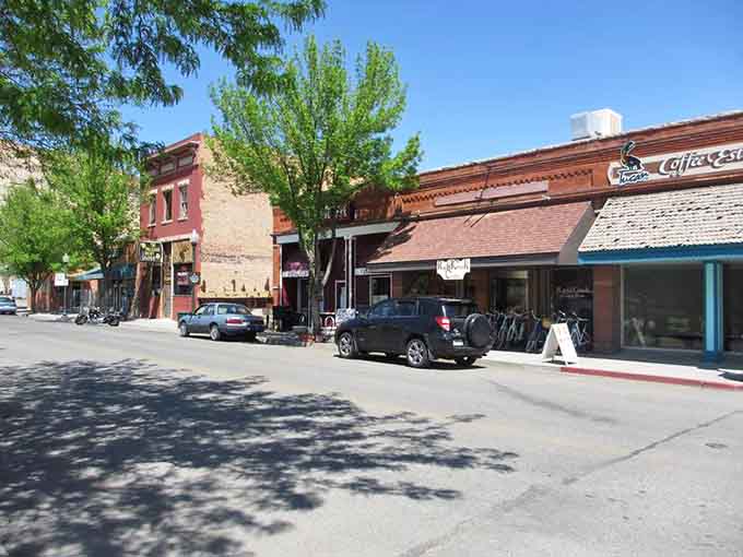 Tree-lined streets and brick buildings create that perfect small-town rhythm where everyone knows the local coffee is always fresh.