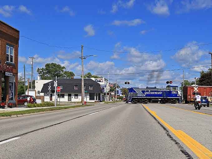 That bright blue locomotive crossing Main Street adds unexpected charm to your Tuesday grocery run, absolutely free entertainment.