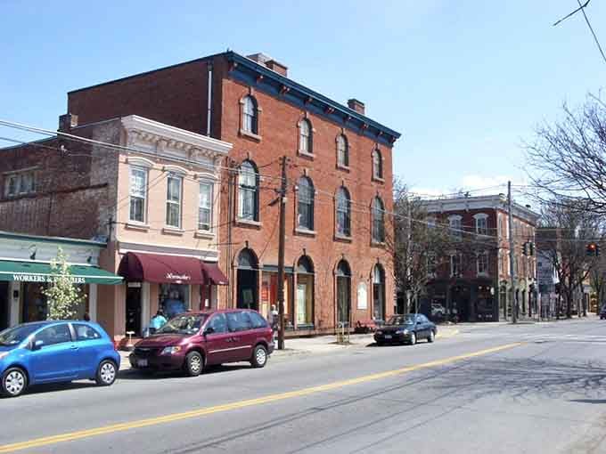 Brick facades with arched windows stand proudly along quiet streets that have witnessed generations of community life unfold.