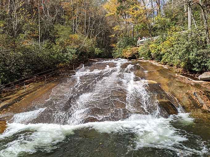 Autumn colors frame the rushing water as it polishes smooth rock into the perfect natural playground.