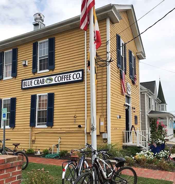 The cheerful yellow building stands proud on the corner, flags flying like it's celebrating coffee every day.