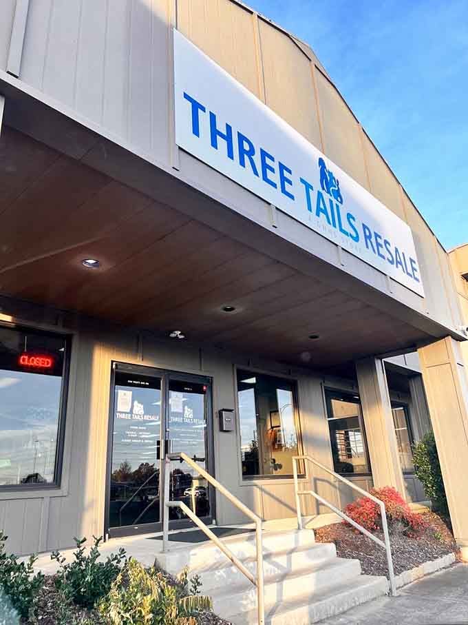 The covered entrance and bright blue lettering create an inviting gateway to secondhand treasures with a purpose.