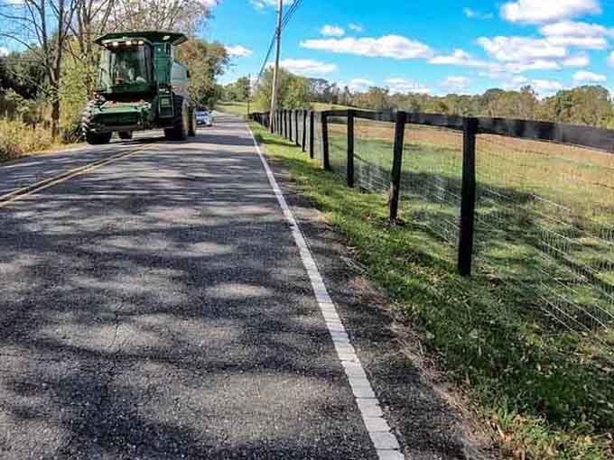 Farm equipment shares the road with travelers, a reminder that real agriculture still thrives in these fertile fields.