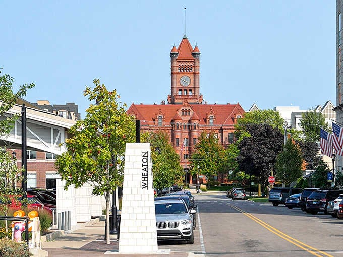 The courthouse tower rises in terracotta glory against green trees, anchoring downtown with Victorian-era grandeur that commands attention and respect.