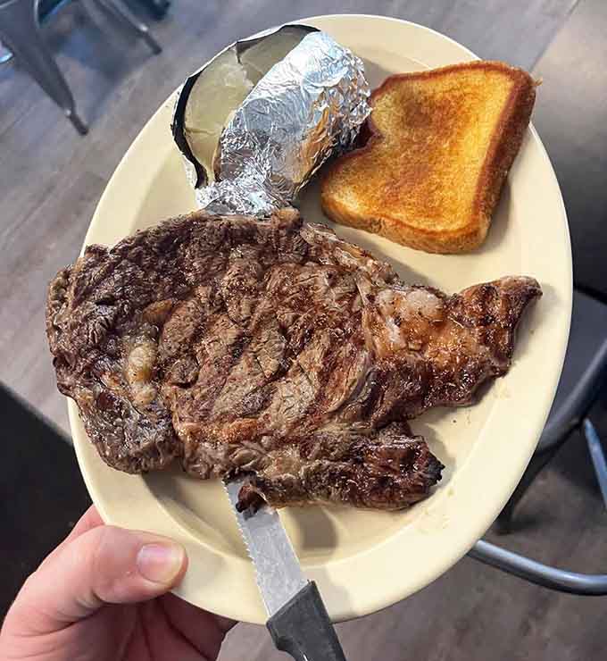 That massive steak with a foil-wrapped potato and buttered toast is breakfast for someone who means serious business this morning.