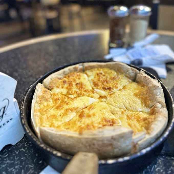 A white pizza so loaded with cheese it practically glows with dairy-based happiness and joy.