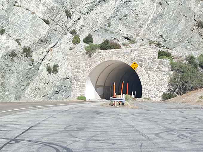 Stone-faced tunnels carved through solid rock, offering brief shade before revealing another jaw-dropping vista beyond.