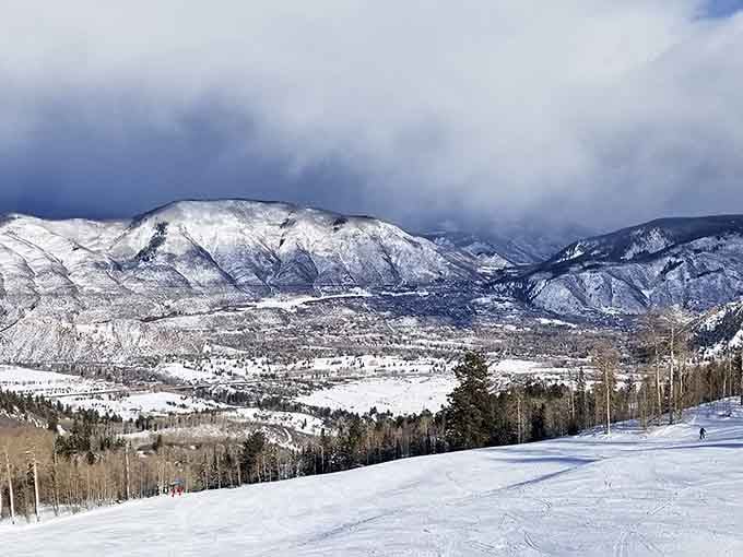 Winter transforms the valley into a snow-globe scene where skiers find their happy place on pristine slopes.
