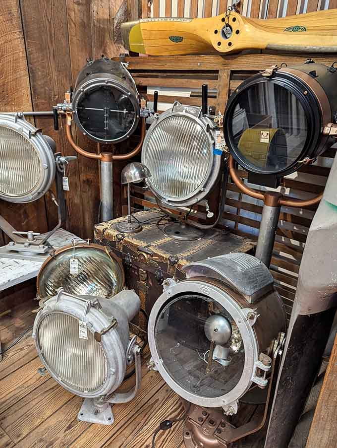 Industrial searchlights stand ready like sentinels, their massive lenses having once illuminated everything from warehouses to movie sets.