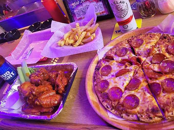 Wings, pizza, fries, and beer: the four food groups of a properly lived life, all together.