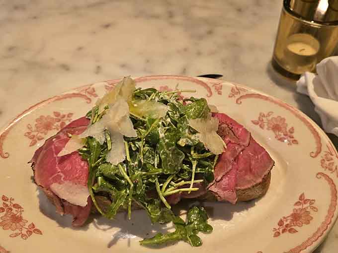 Paper-thin beef topped with fresh greens proves that sometimes the simplest preparations are the most stunning and satisfying.