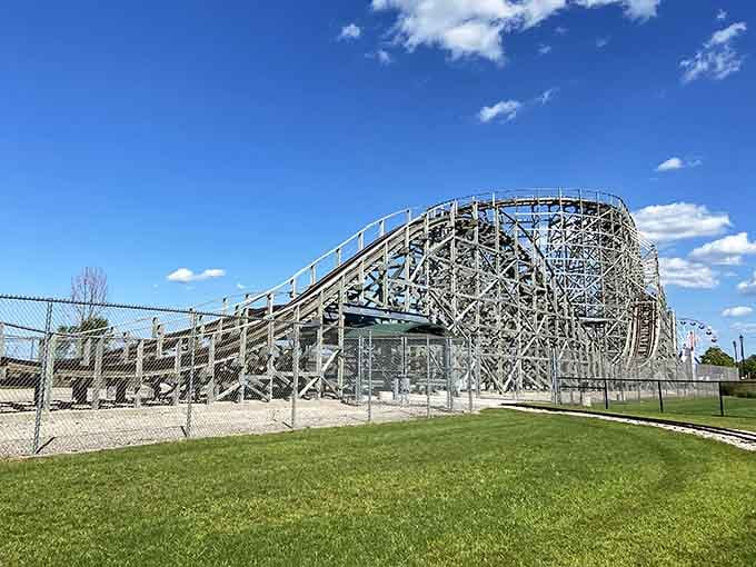 The wooden coaster's graceful curves and latticed framework stand as testament to traditional engineering that still delivers genuine excitement.