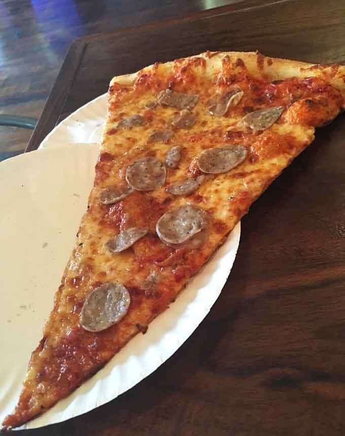 Italian sausage never looked so intimidating, or so delicious, spread across this magnificent triangle of dough and dreams.