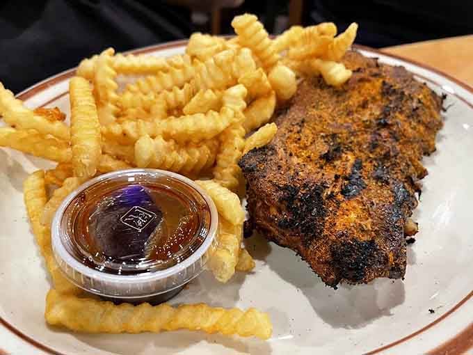 Waffle fries meet perfectly seasoned ribs in a pairing that would make any comfort food enthusiast weep with joy.
